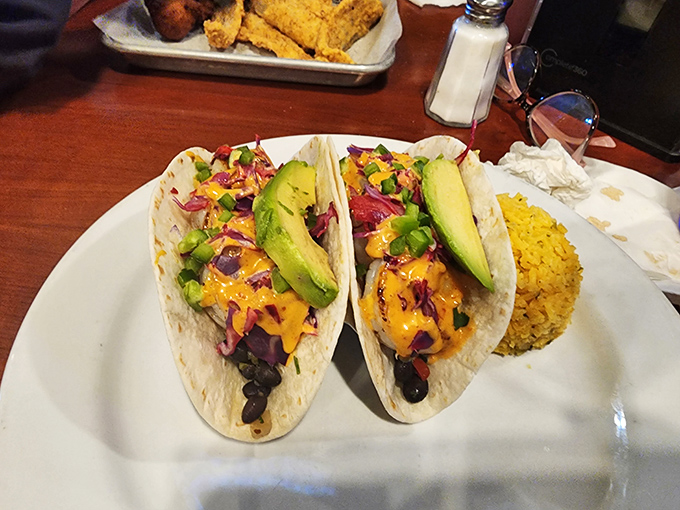 Not just a fish joint! These vibrant tacos topped with fresh avocado and colorful slaw prove The Deck Down Under knows its way around land-based delights too.