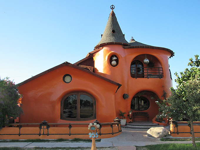 This whimsical orange structure, known locally as "The Smurf House," proves desert architecture doesn't have to play by conventional rules.