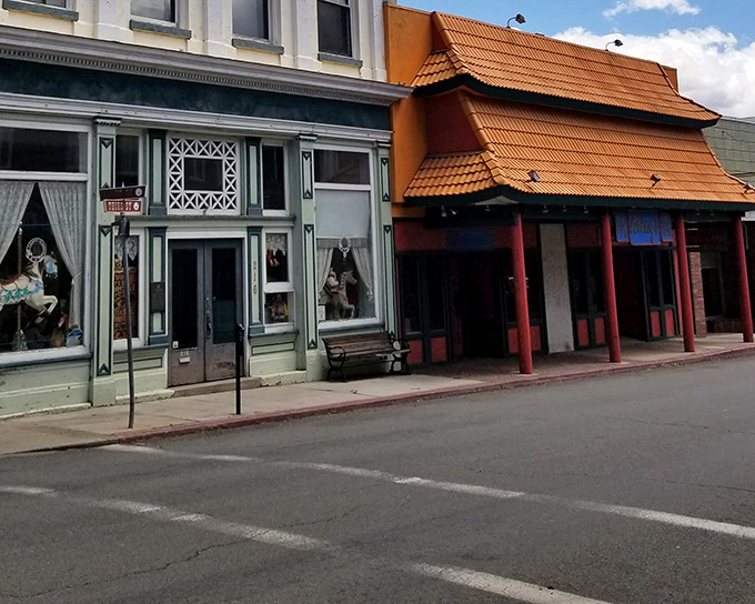 Sunlight plays across storefronts where modern businesses thrive in buildings that witnessed the California Gold Rush. History with a side of commerce.