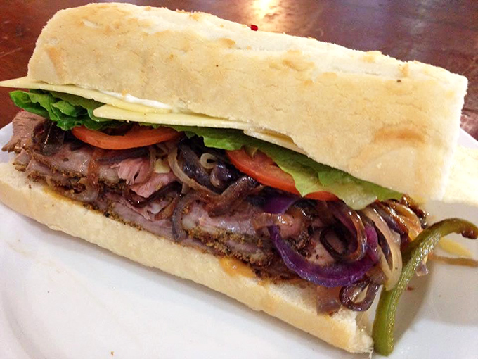 Behold the Mississippi Pot Roast sandwich – where tender beef, caramelized onions, and pepperoncini create a flavor symphony that would make Mark Twain homesick.