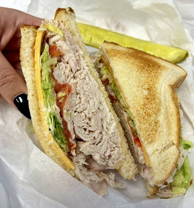 This isn't just a turkey sandwich – it's an engineering marvel of perfectly toasted bread, generous meat, and the precise lettuce-to-mayo ratio that sandwich dreams are made of.