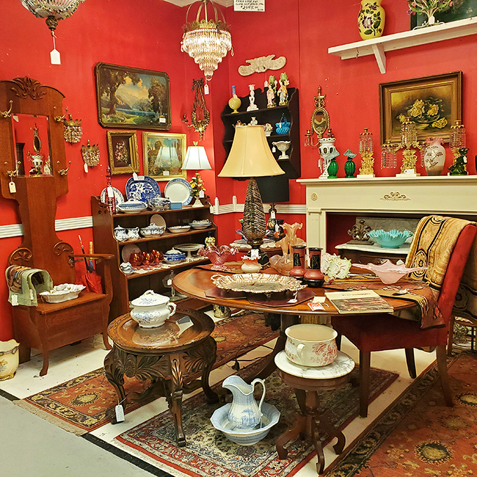 A crimson-walled booth creates the perfect stage for antique treasures. That fireplace mantel isn't just furniture&mdash;it's an invitation to reimagine your living room.