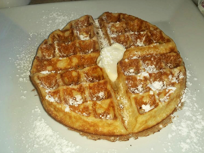 Golden perfection with a dusting of powdered sugar. This waffle's crisp exterior gives way to a fluffy interior that will haunt your breakfast dreams.