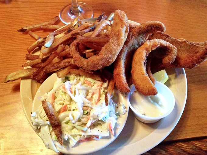 Crispy golden onion rings and those famously "greasy" fries frame the star attraction. The coleslaw provides a cool, creamy counterpoint to all that delicious crunch. 