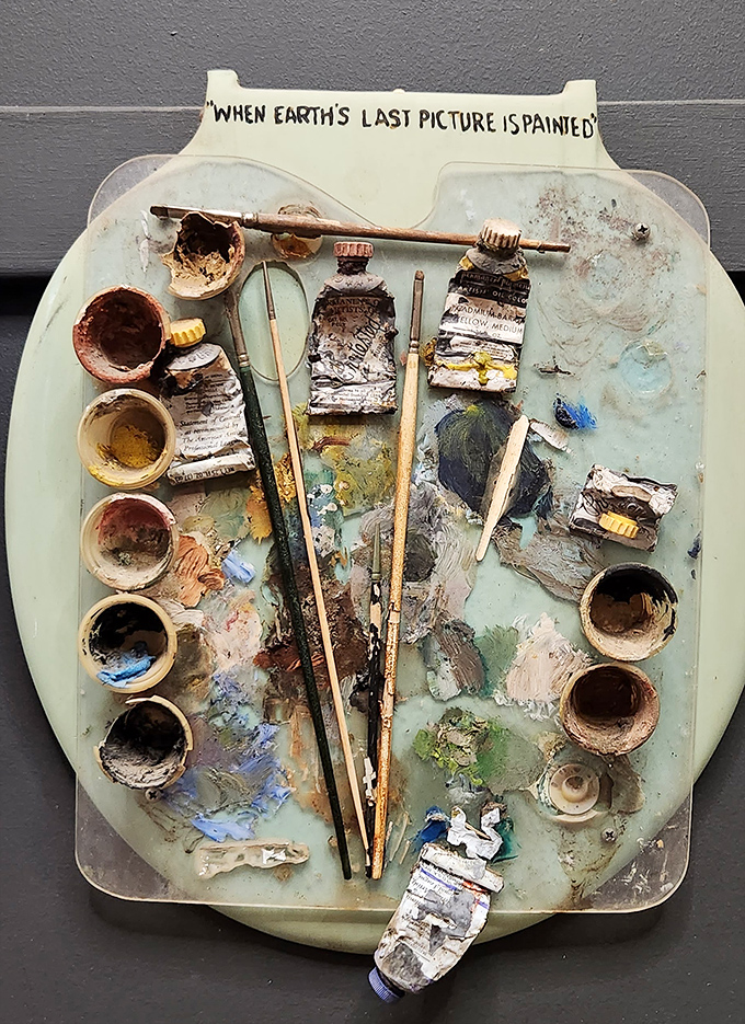 "When Earth's Last Picture is Painted" transforms a toilet seat into an artist's palette, complete with paint-splattered brushes and tiny cups of color.