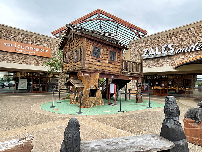 This whimsical treehouse play area offers kids a magical break while parents debate whether they "need" that fifth pair of discounted shoes.