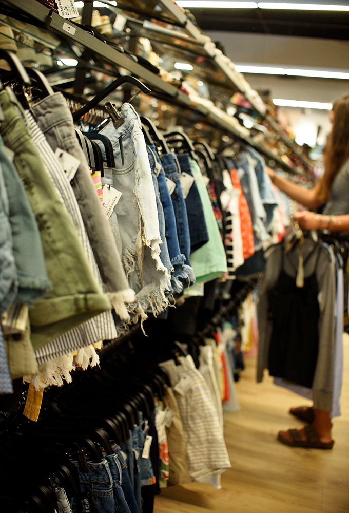 The thrill of the hunt captured in one frame&mdash;fingers rifling through possibilities, each hanger a potential style jackpot.