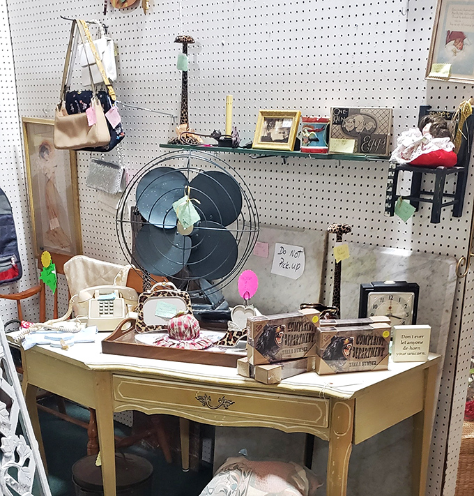 A cream-colored desk becomes command central for vintage finds, complete with retro fan and nostalgic trinkets. Marie Kondo would have a panic attack here!