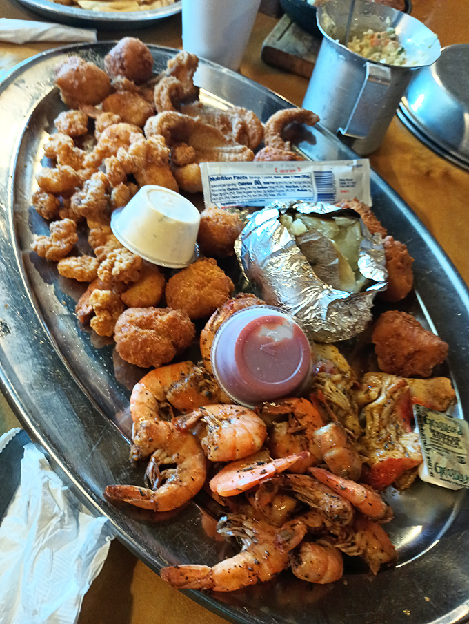 This isn't just a seafood platter&mdash;it's a celebration on metal. Crispy catfish nuggets, seasoned shrimp, and a loaded potato create the holy trinity of satisfaction.