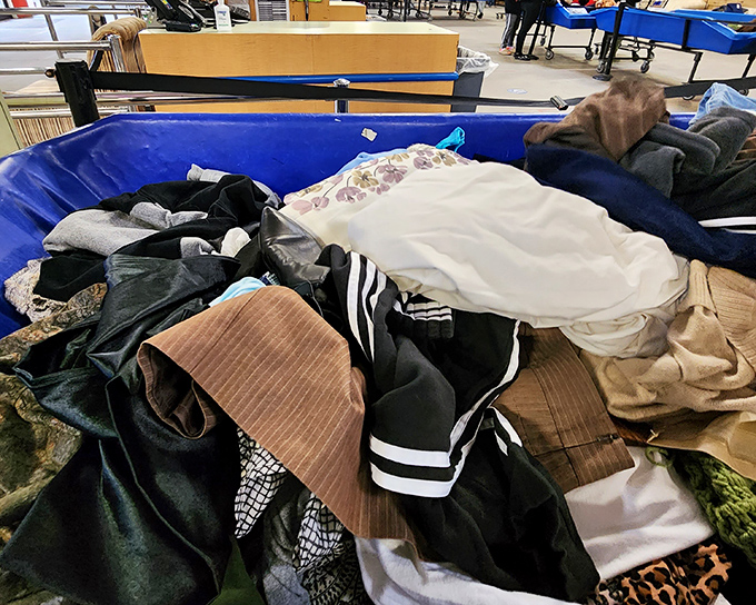 Textile treasure hunting at its finest. Somewhere in this blue bin of possibilities lies someone's future favorite sweater, just waiting to be discovered.