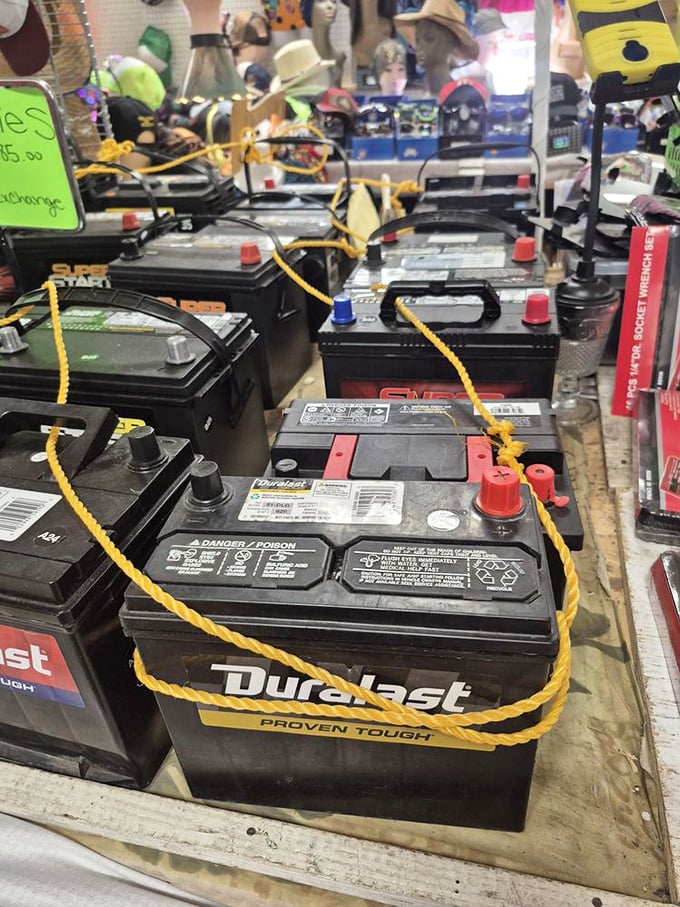 Car batteries lined up like soldiers ready for duty. Even at a flea market, practical necessities stand at attention alongside whimsical finds.