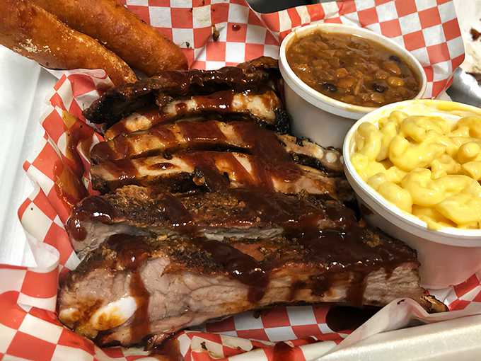 These ribs have the kind of bark that makes tree bark jealous, with meat so tender it practically surrenders to your fork before you even touch it.