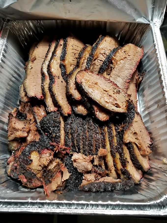Behold the brisket in all its bark-encrusted glory&mdash;each slice bearing that pink smoke ring that makes barbecue enthusiasts weak in the knees.