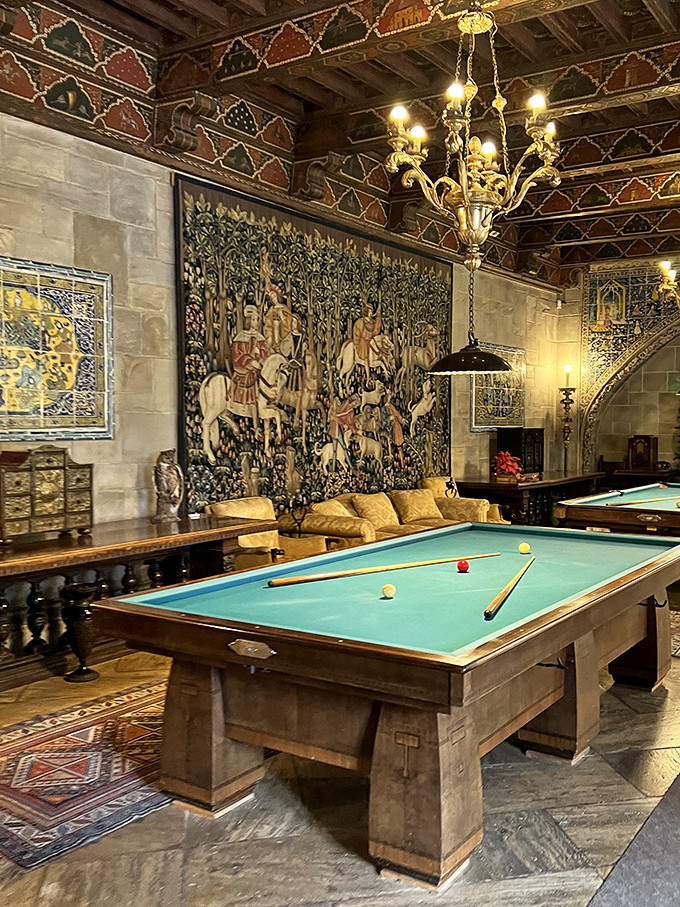 Nothing says "casual game night" like shooting pool beneath medieval tapestries. This billiard room makes your man cave look like, well, an actual cave.