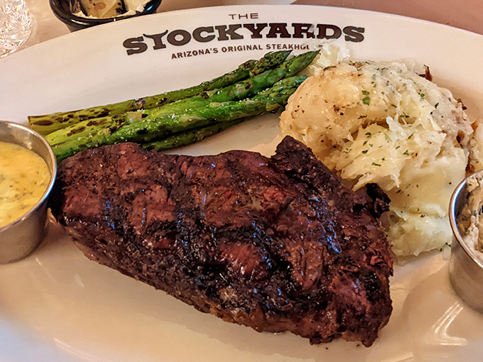 Behold the star of the show: a perfectly seared bison ribeye flanked by asparagus soldiers and whipped potatoes. This isn't dinner &ndash; it's destiny.