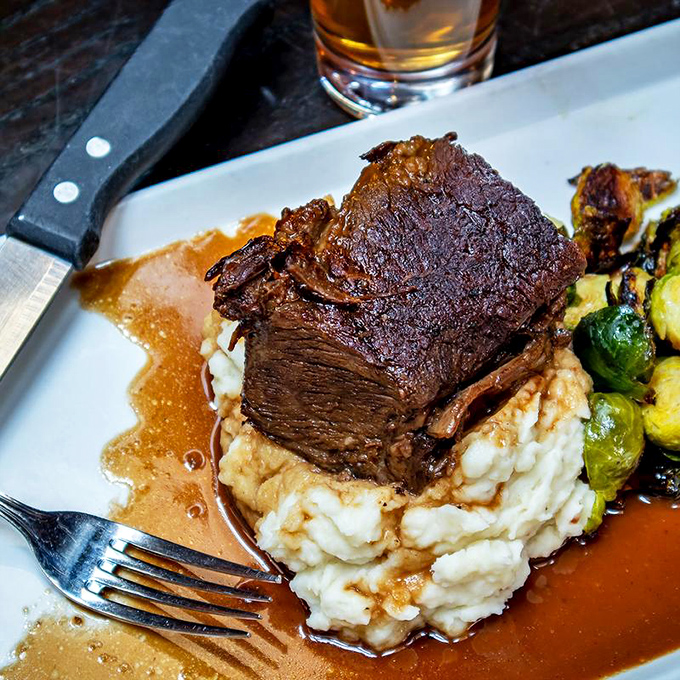 The legendary braised short ribs in all their glory&mdash;a tower of tender meat that doesn't so much fall off the bone as leap joyfully onto your fork.