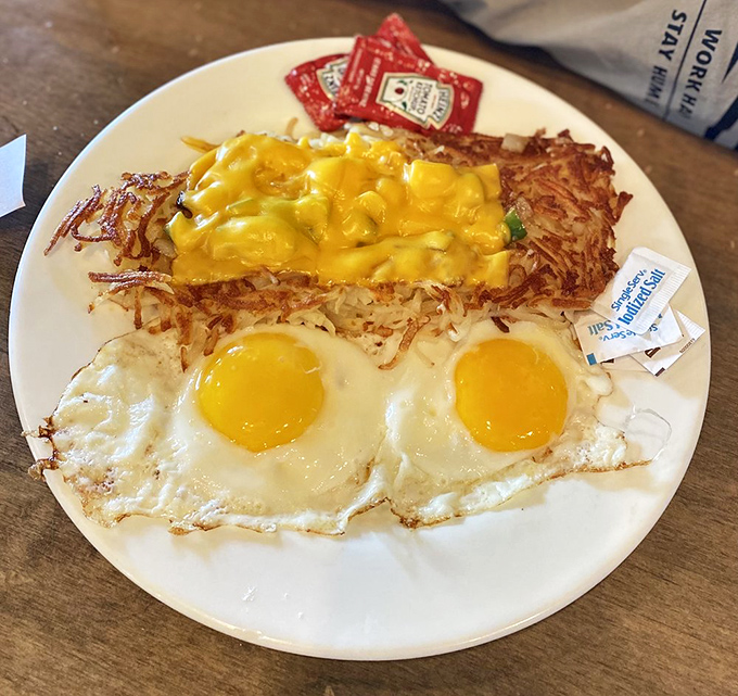 Sunny-side perfection meets golden hash browns in a plate that screams "good morning" louder than your first coffee.
