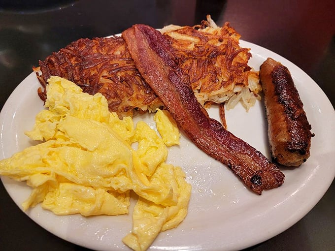 Sunshine on a plate! Perfectly scrambled eggs, crispy hash browns, and bacon that's achieved that mythical balance between crisp and chewy.