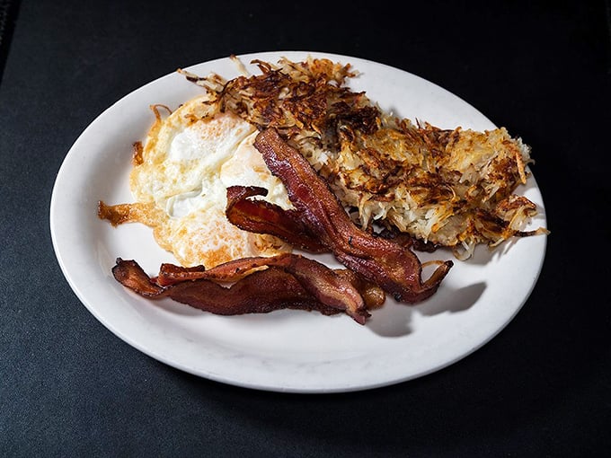 Eggs with that perfect sunny-side up glow, crispy hash browns with the ideal crunch-to-softness ratio, and bacon cooked to that magical sweet spot.