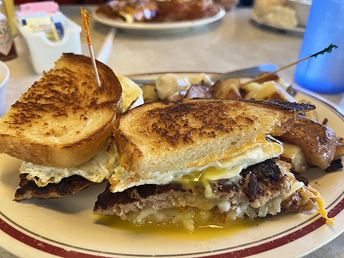 This breakfast sandwich isn't just breaking fast&mdash;it's breaking hearts with melty cheese cascading over perfectly grilled meat between golden toast.
