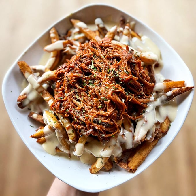 Brisket poutine that makes Canadians jealous. These fries, smothered in slow-cooked meat and cheese sauce, are what comfort food dreams are made of.