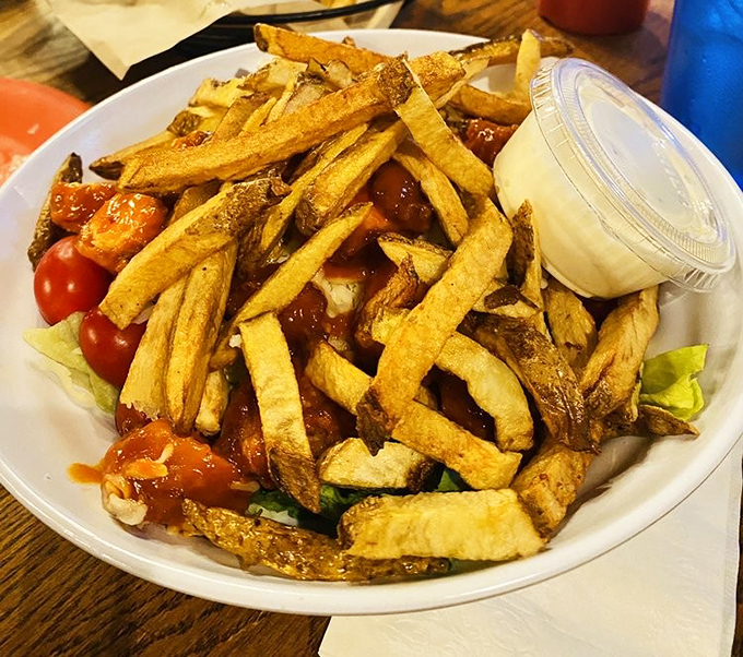 These aren't just fries—they're golden potato masterpieces, crisp on the outside, fluffy within, served with fresh veggies that make you feel slightly virtuous.