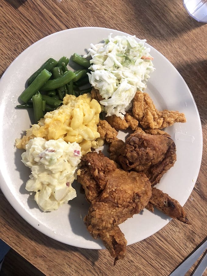 Comfort food perfection on a plate: golden fried chicken, creamy mac and cheese, fresh green beans, and coleslaw. Your diet can resume tomorrow.
