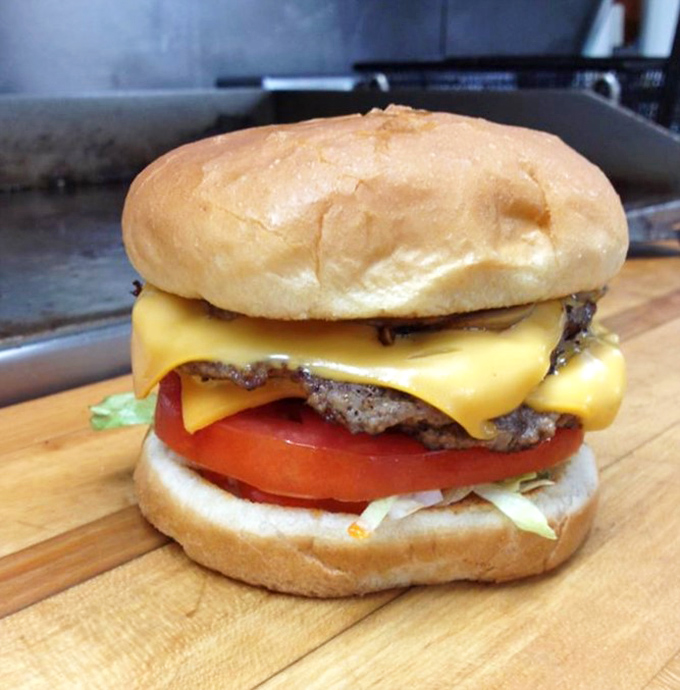 Not just a cheeseburger, but a monument to American ingenuity: hand-formed patty, melty cheese, fresh veggies, and a perfectly toasted bun.