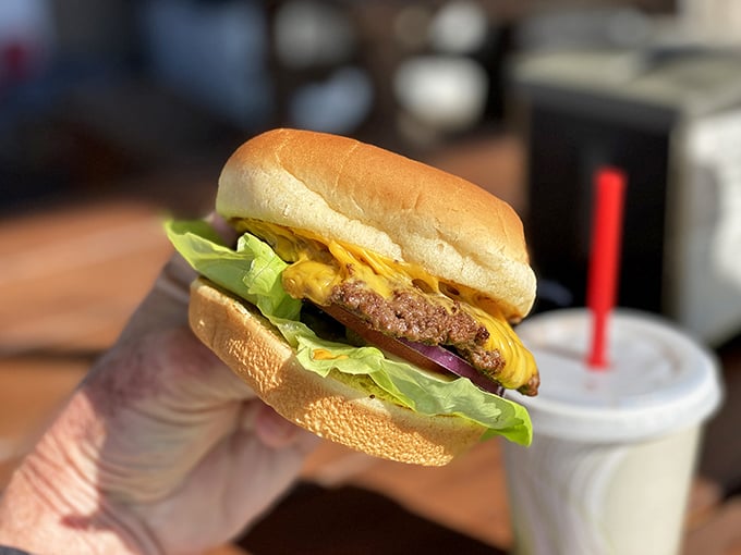 Behold: the burger in its natural habitat. No filter needed when melted cheese cascades perfectly over a hand-formed patty.