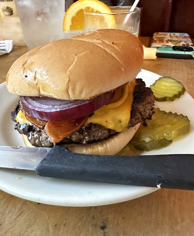 Behold the cheeseburger in its natural habitat&mdash;perfectly seared, cheese melting like a sunset, with pickle sentries standing guard against disappointmen