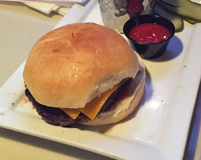 Simplicity perfected: a classic cheeseburger that reminds us why some traditions never need reinvention. The side of ketchup stands ready for duty.