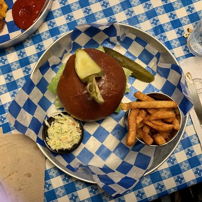 A burger on a pretzel bun with the perfect pickle-to-meat ratio. That coleslaw side cup is the unsung hero your taste buds didn't know they needed.