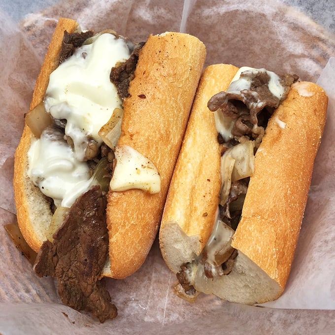 Behold the star of the show &ndash; thinly sliced ribeye embraced by melted cheese on that perfect roll. Poetry in sandwich form.
