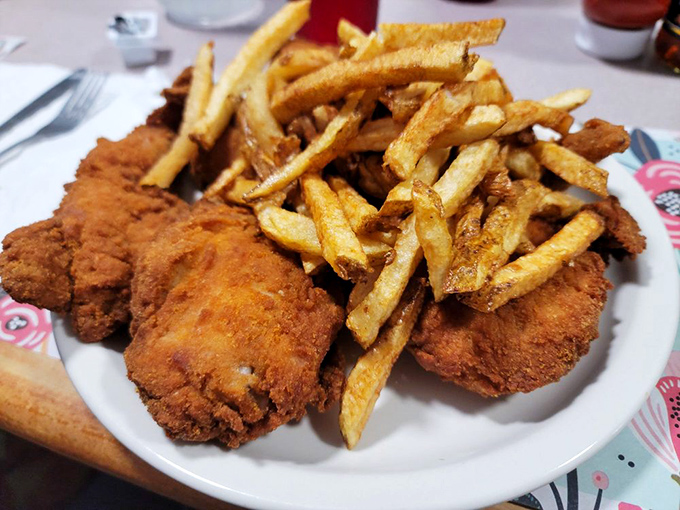 Golden-brown perfection meets hand-cut fries in a plate that doesn't need Instagram filters&mdash;just your immediate, undivided attention.