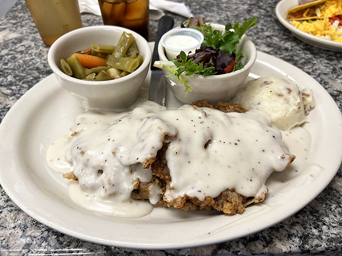 Chicken fried steak smothered in cream gravy that could make a vegetarian weep. Those pickled green beans aren't just a side&mdash;they're a palate-cleansing necessity.