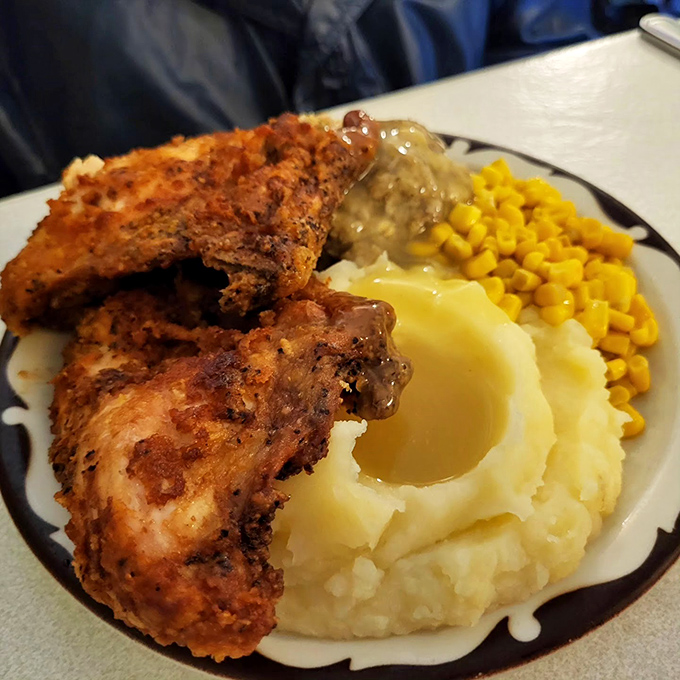 Golden-brown chicken resting beside cloud-like mashed potatoes with a butter lake in the middle&mdash;this isn't a meal, it's edible therapy.