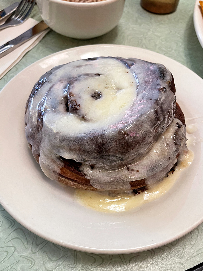 Behold the legendary Ooey Gooey Cinna-Biscuit in its natural habitat, glistening with frosting and practically begging to be photographed before devoured.