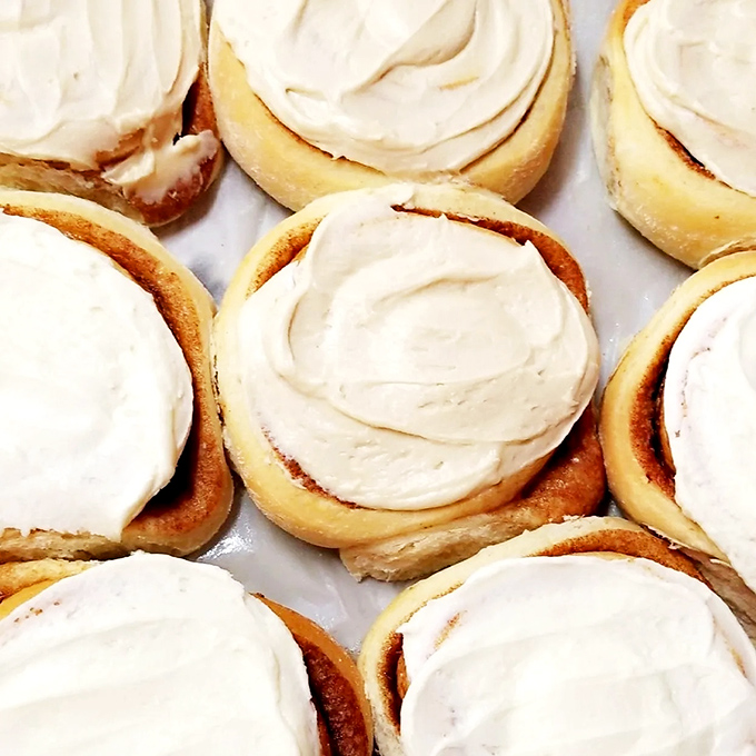 These aren't just cinnamon rolls; they're cloud-like spirals of joy topped with cream cheese frosting that should be classified as a controlled substance.