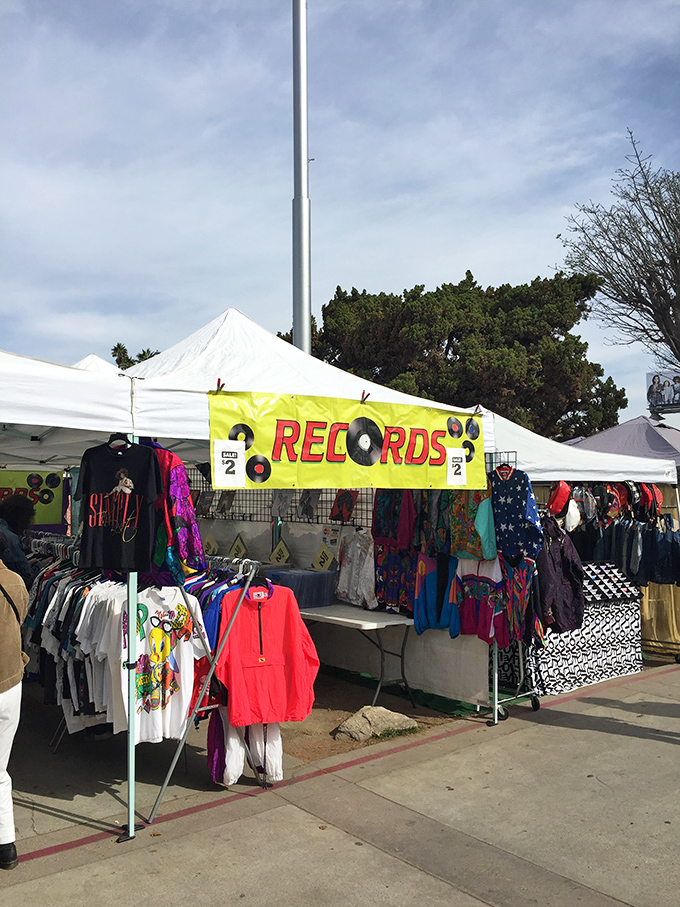 Vinyl records and vintage clothing share space, proving music and fashion are timeless shopping companions. 