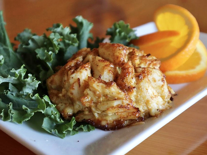 Behold the star of the show&mdash;a golden-brown crab cake that's more crab than cake, resting on a bed of greens like royalty.