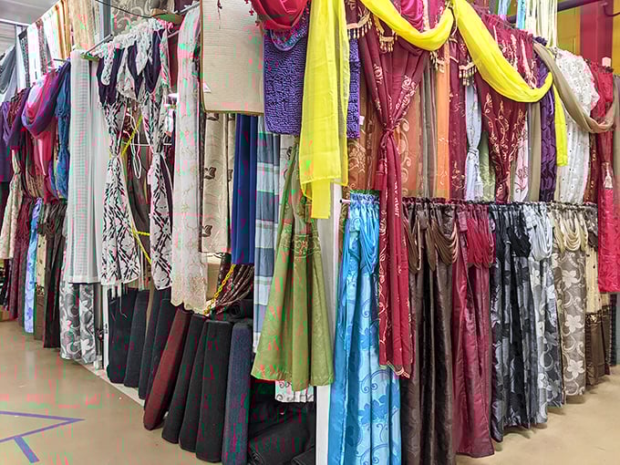 A kaleidoscope of fabrics hangs like colorful promises&mdash;each scarf and curtain waiting to transform a house into someone's dream home.