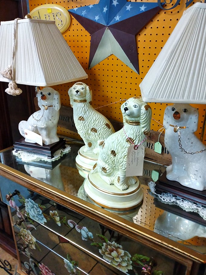 Staffordshire-style dog lamps stand guard over vintage treasures. These ceramic canines have watched decades pass, now ready for their second act.