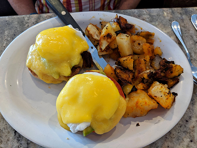 Eggs Benedict that would make the Pope jealous. Golden hollandaise cascades over perfectly poached eggs like a sunrise worth setting your alarm for.