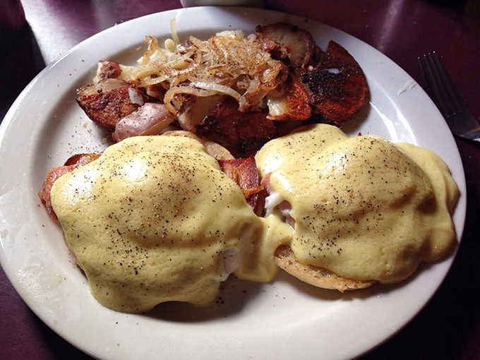 Behold the star attraction: eggs Benedict with hollandaise so rich it could buy a small island. The golden sauce cascades like breakfast lava.