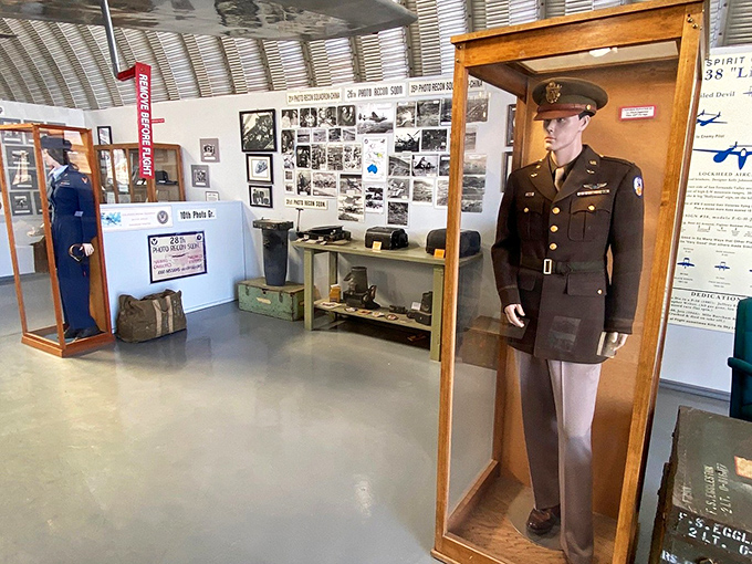 Military uniforms through the decades stand at eternal attention, silently telling stories of the men and women who once filled them.