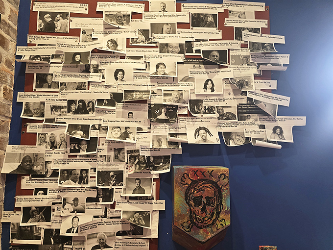 A wall of infamous faces stares back at visitors, creating an unsettling collage of true crime history. Each headline represents a dark chapter in American culture.