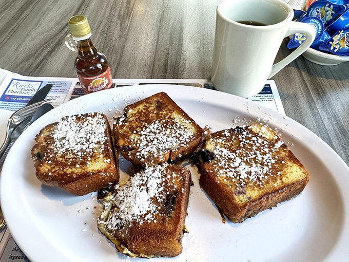French toast that's had a proper education&mdash;golden-crisp exterior, custardy interior, and a snowfall of powdered sugar that makes resistance futile.