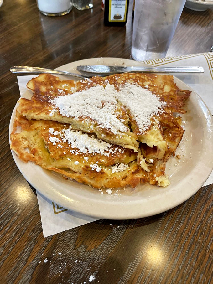 The legendary french toast that launches road trips. Dusted with powdered sugar and sporting that perfect golden crust, it's breakfast as an art form.
