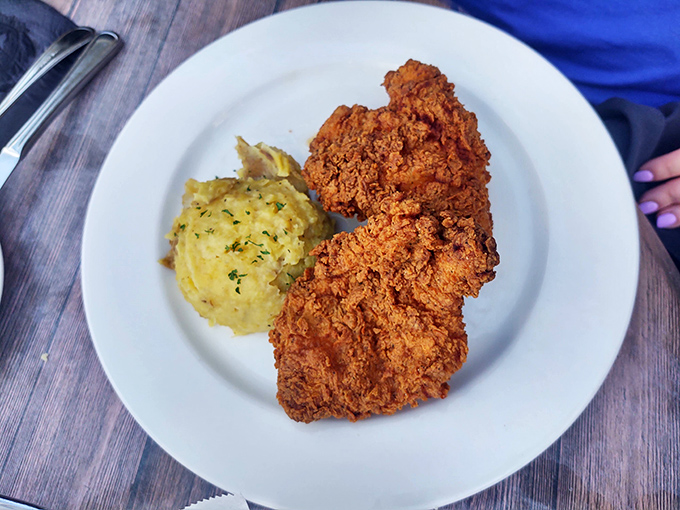 Golden-fried chicken with a crust so perfect it deserves its own fan club, paired with creamy mashed potatoes that clearly never came from a box.