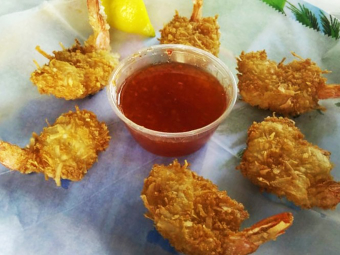 Golden-battered shrimp that snap with each bite, arranged like a sunburst around that tangy cocktail sauce. This is why people make pilgrimages here.
